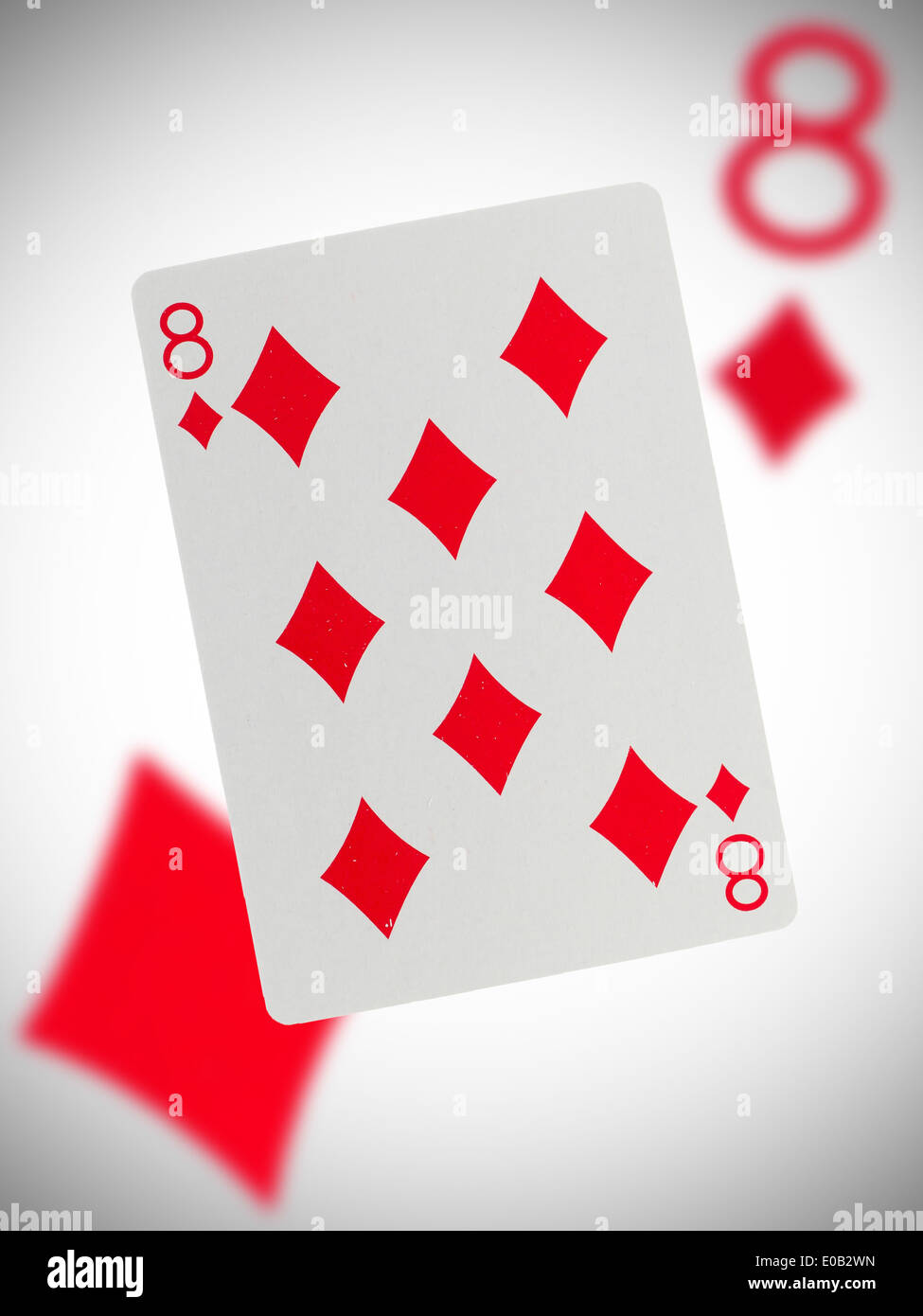 Playing card with a blurry background eight Stock Photo - Alamy