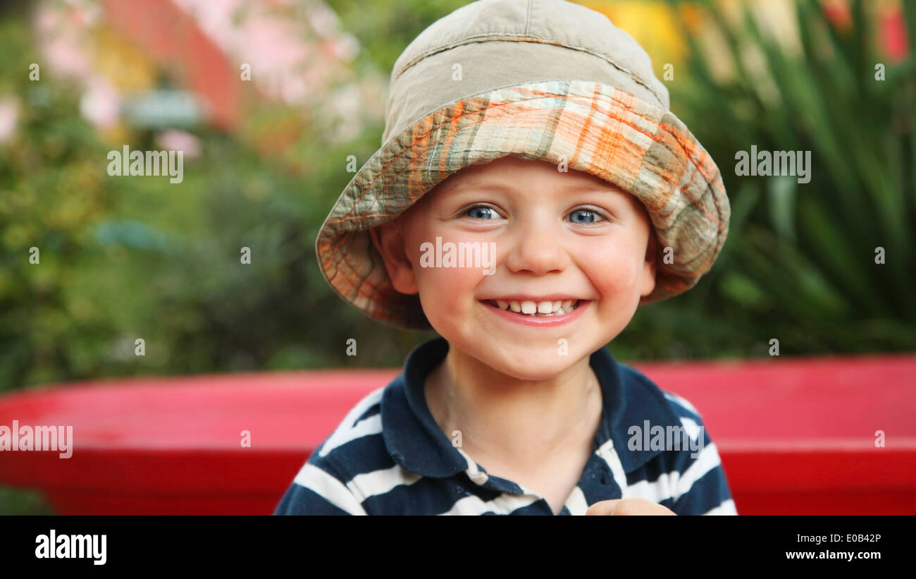 Portrait of smiling little boy wearing sun hat Stock Photo - Alamy