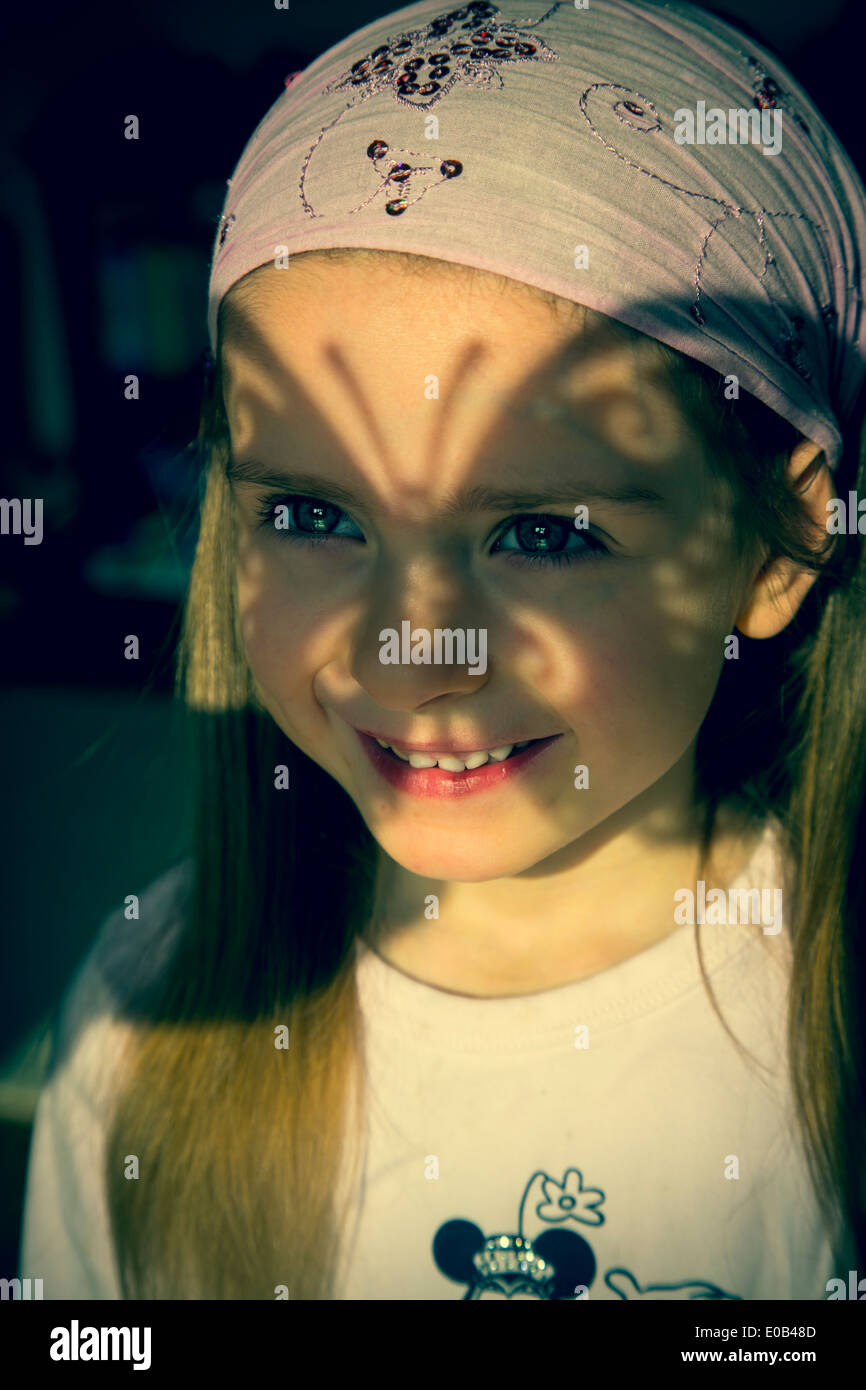 Portrait of little girl with butterfly-shaped shadow in her face Stock ...