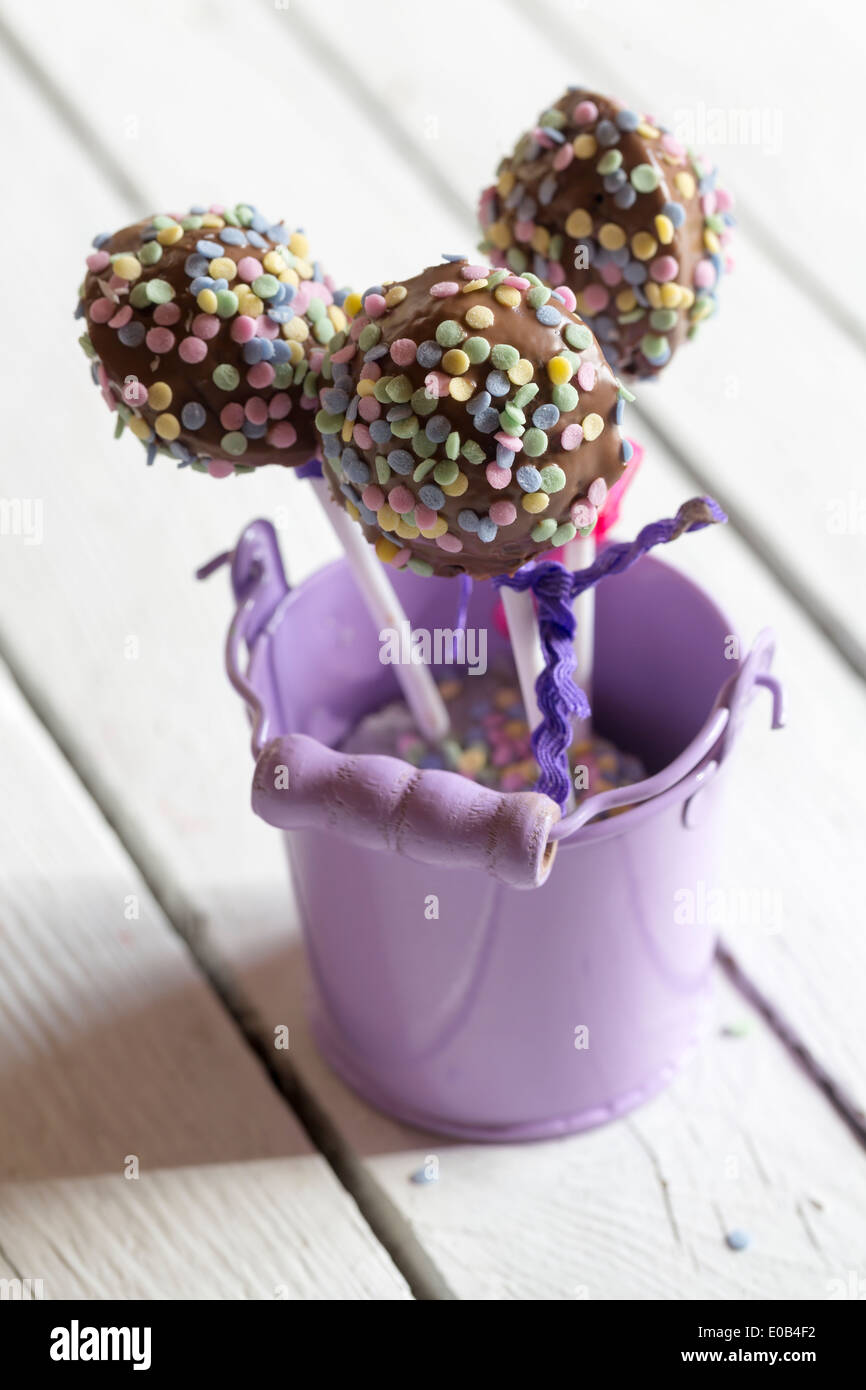 Pail with three cake pops on white ground Stock Photo - Alamy