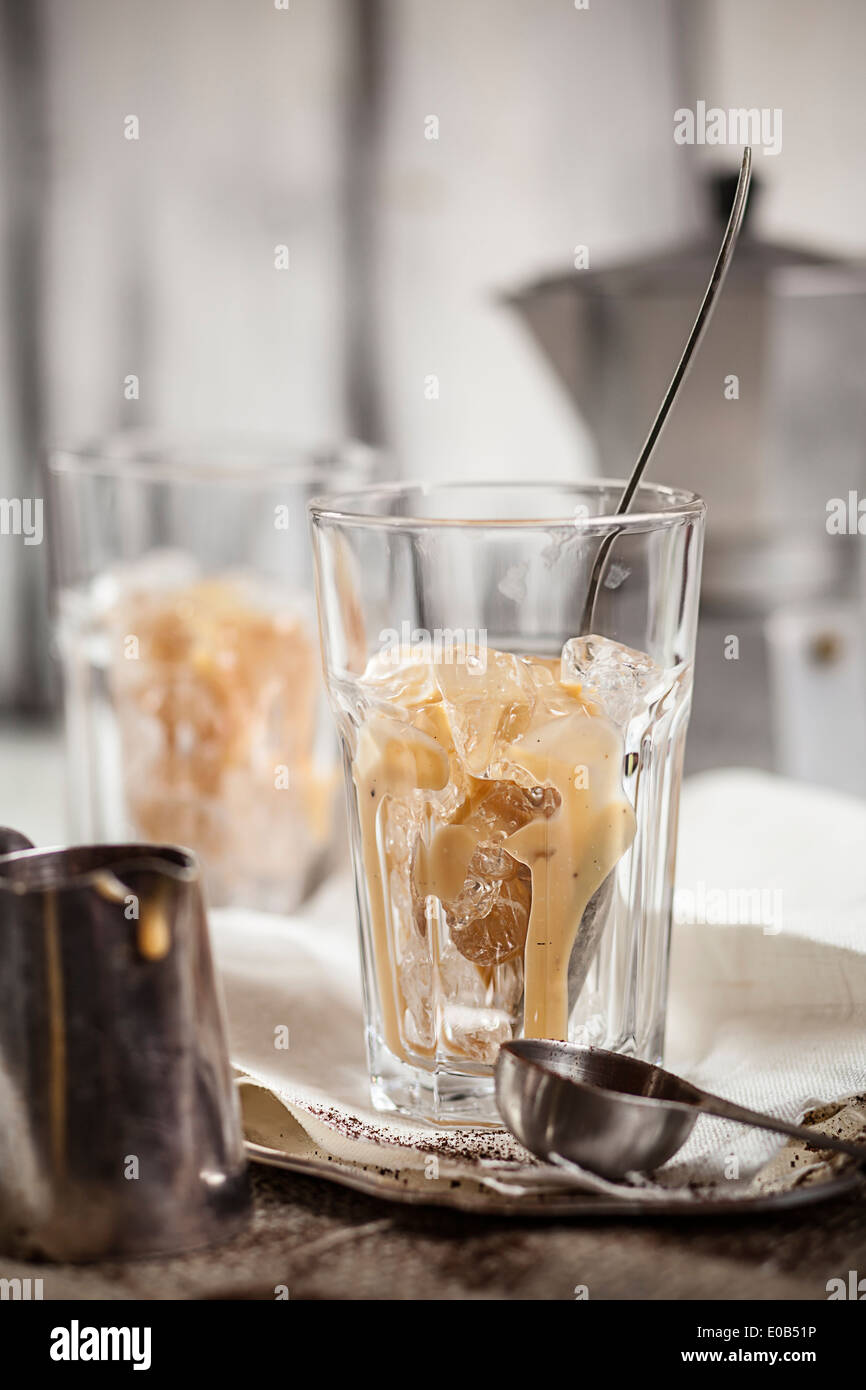 Sweet condensed milk in drinking glass filled with ice Stock Photo - Alamy