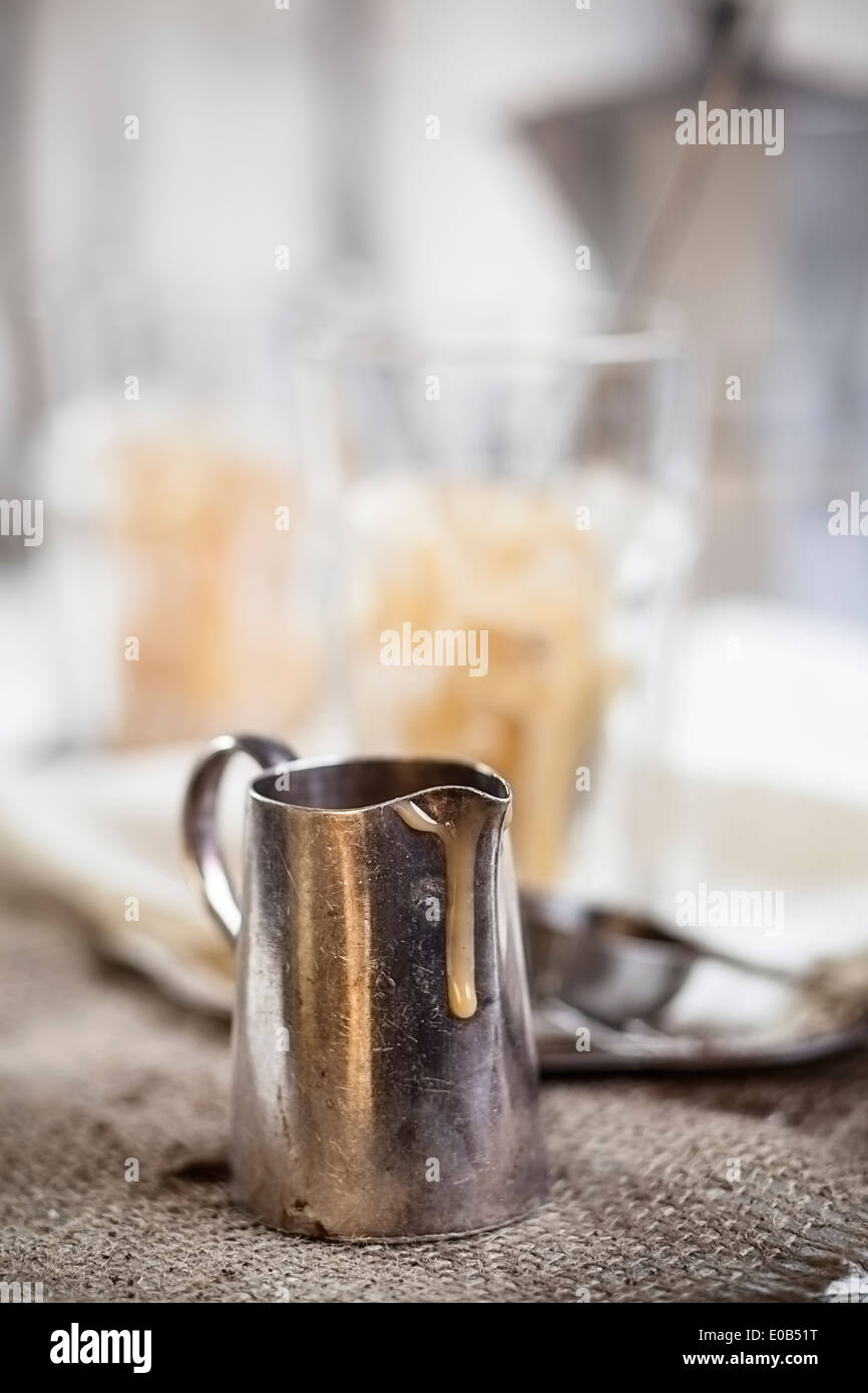 Milk jug with drips of condensed milk Stock Photo - Alamy