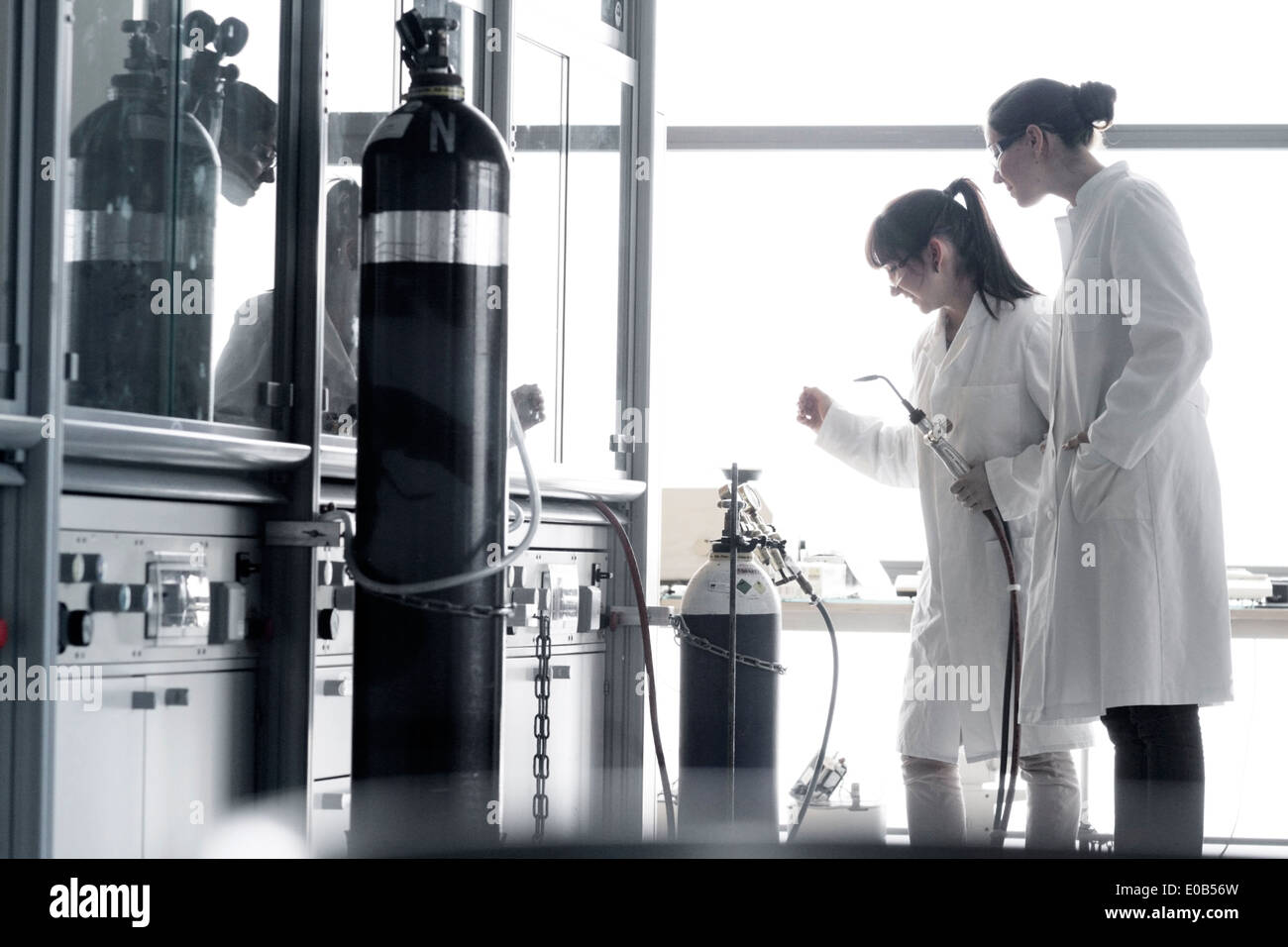 Two young female chemistry students in lab Stock Photo - Alamy