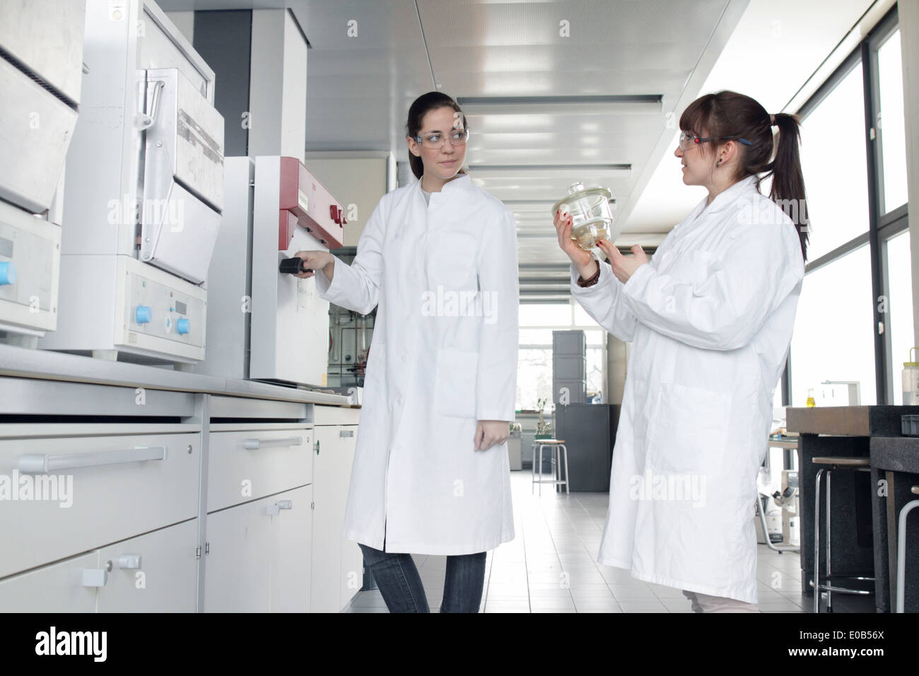 Two young female chemistry students in lab Stock Photo - Alamy