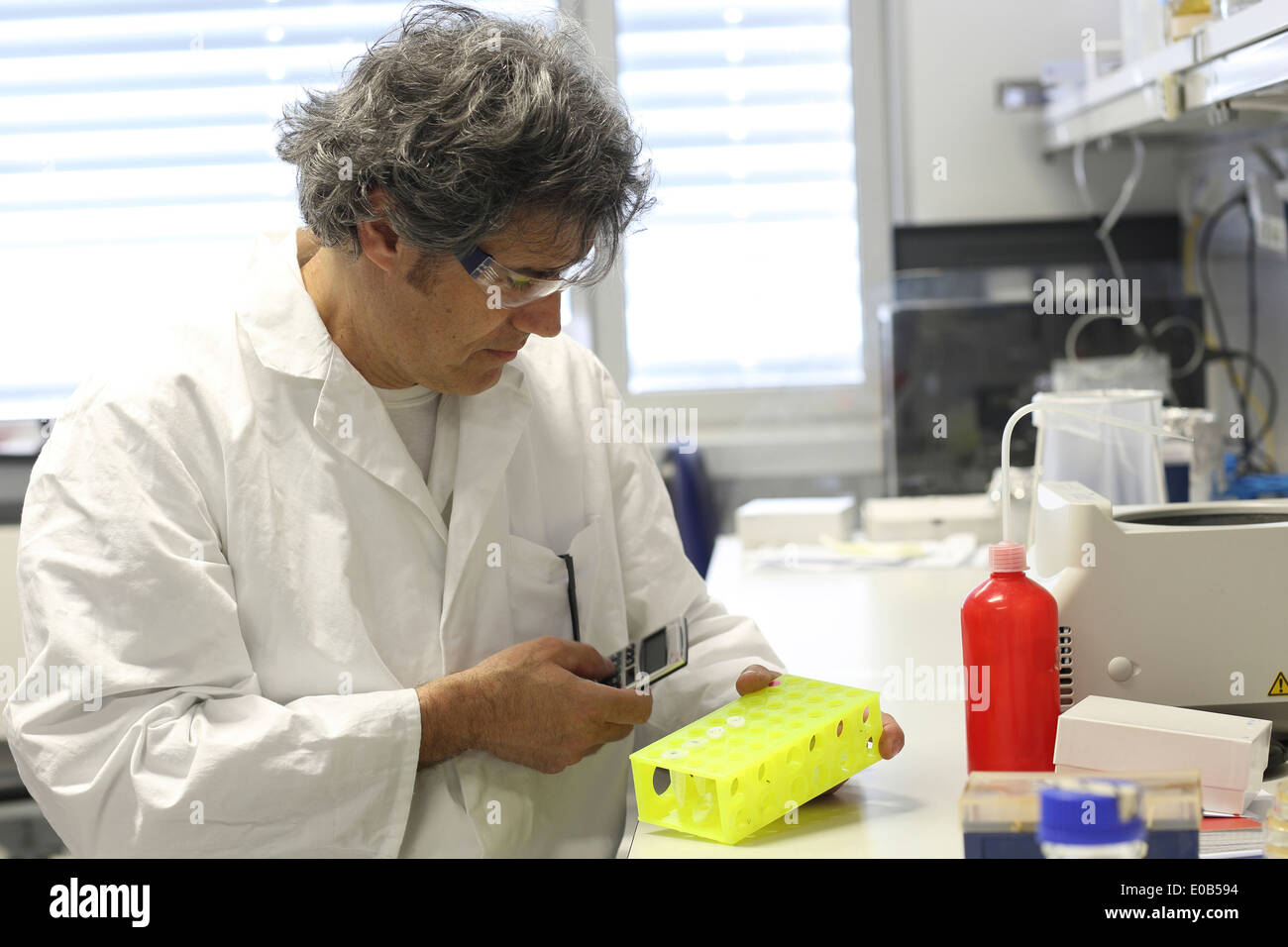 Germany, Freiburg, Scientist in laboratory calculating substance ...
