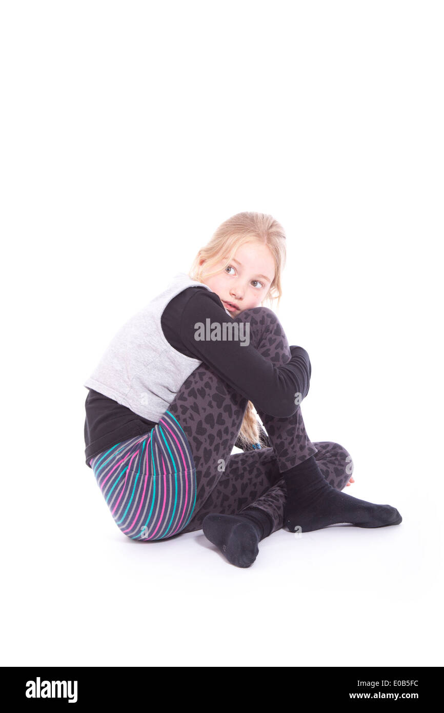 young frightened girl in studio against white background Stock Photo ...