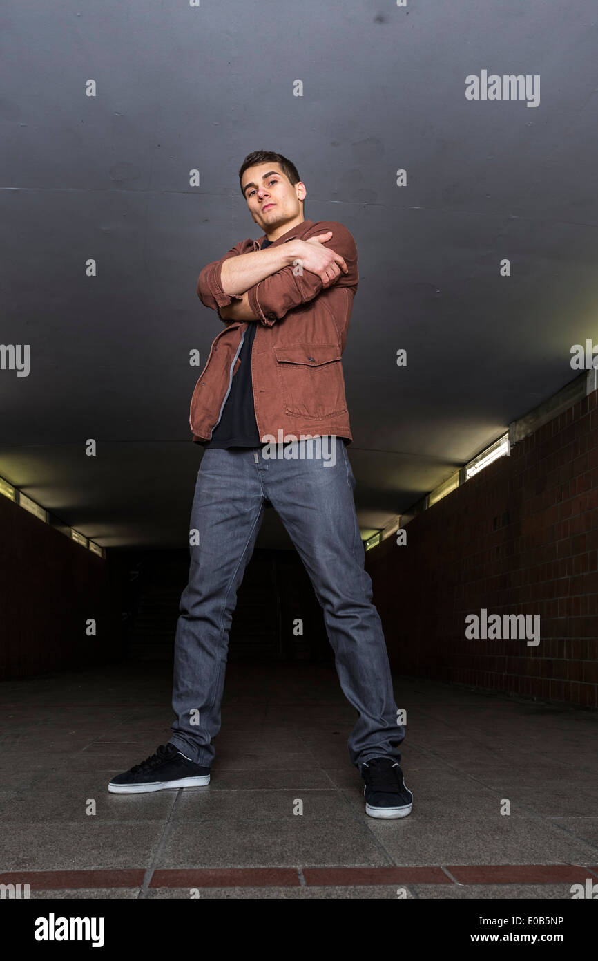 Young breakdancer with crossed arms standing in underpass Stock Photo ...