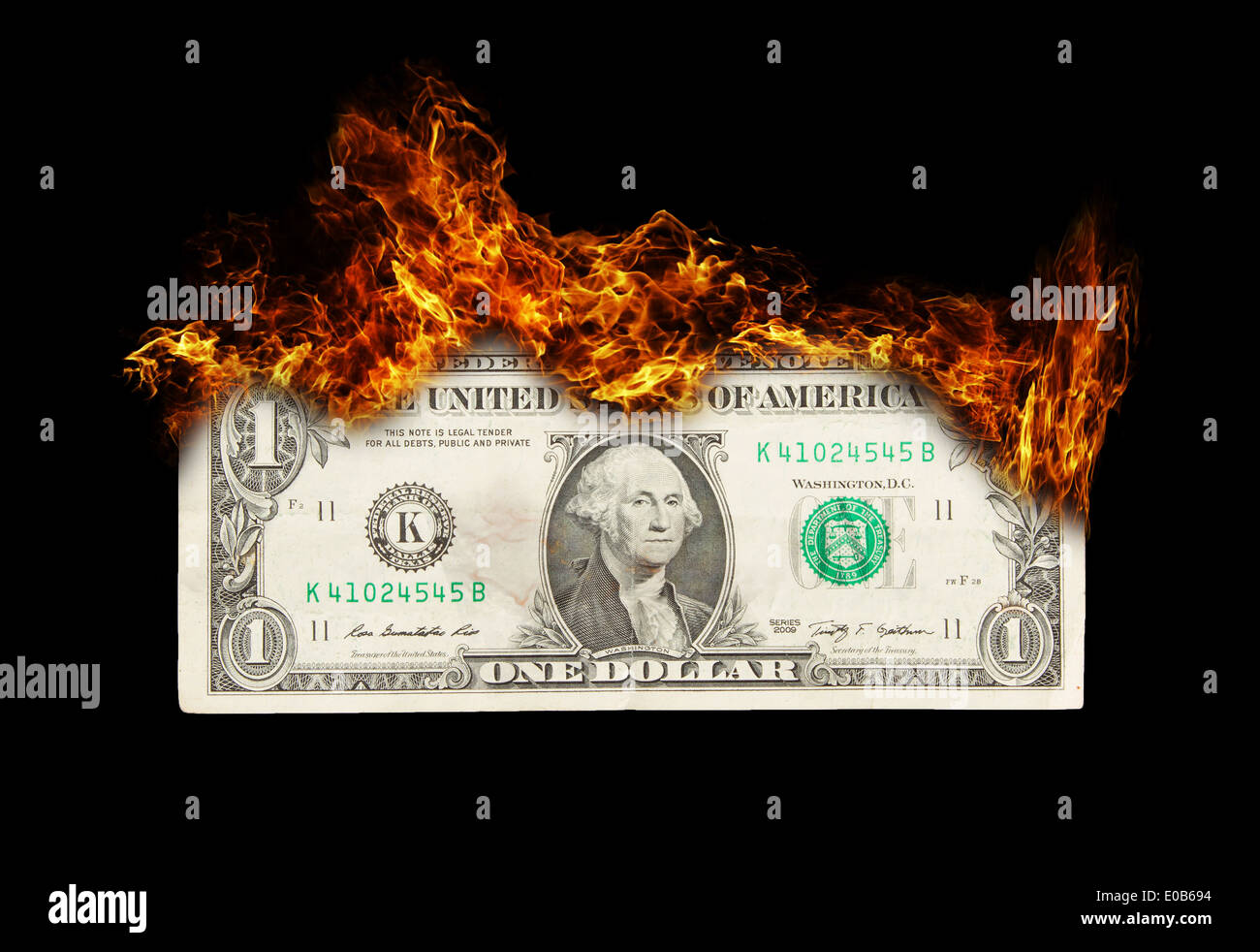 Burning dollar bill symbolizing careless money management and the phrase money to burn Stock ...
