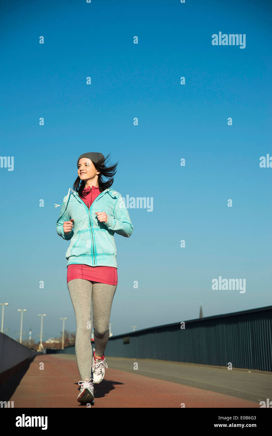 Young female jogger on the move Stock Photo - Alamy