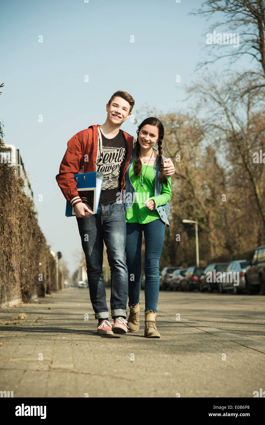 Teenage couple walking side by side Stock Photo - Alamy