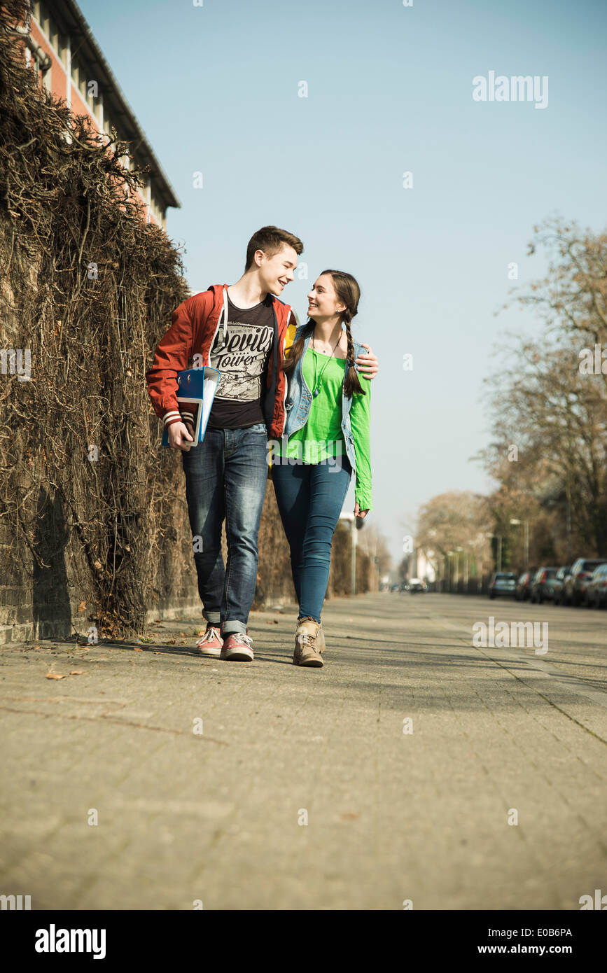 Teenage couple walking side by side Stock Photo - Alamy