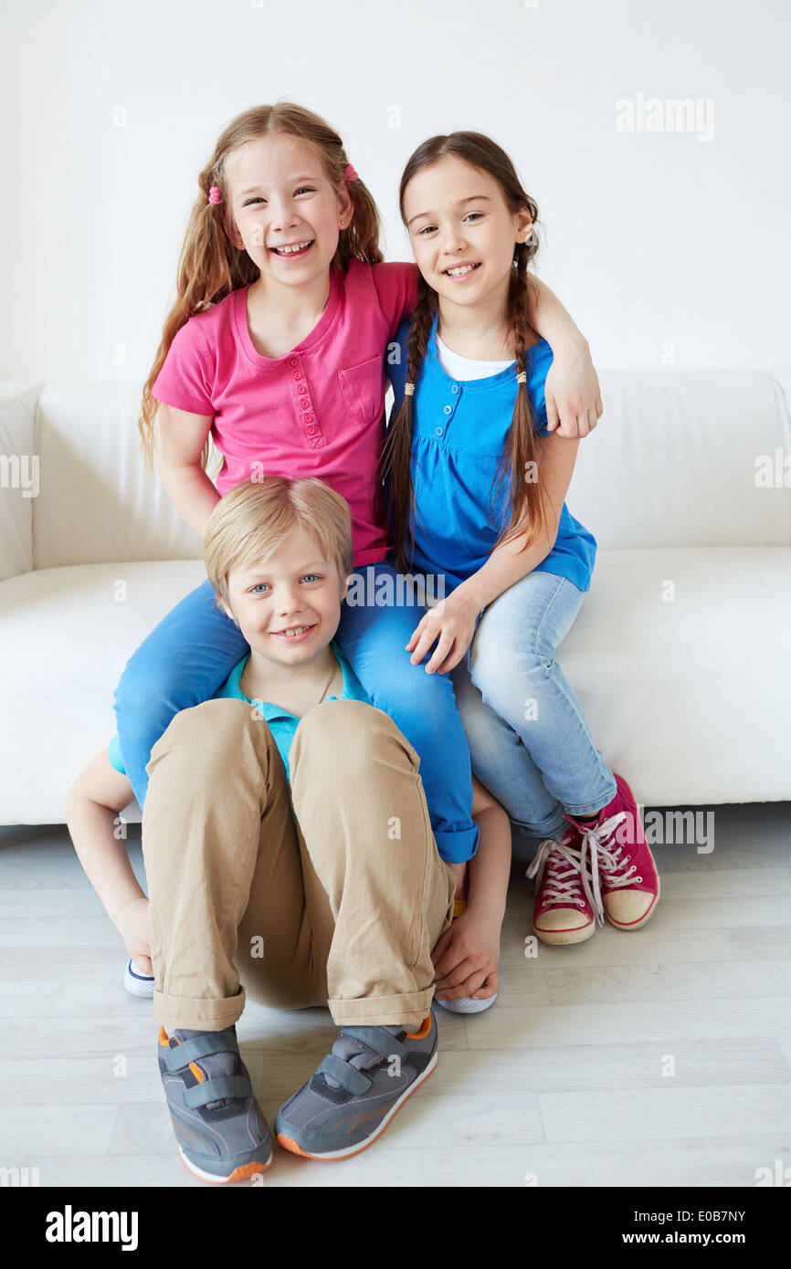 Three little friends looking at camera with smiles Stock Photo - Alamy