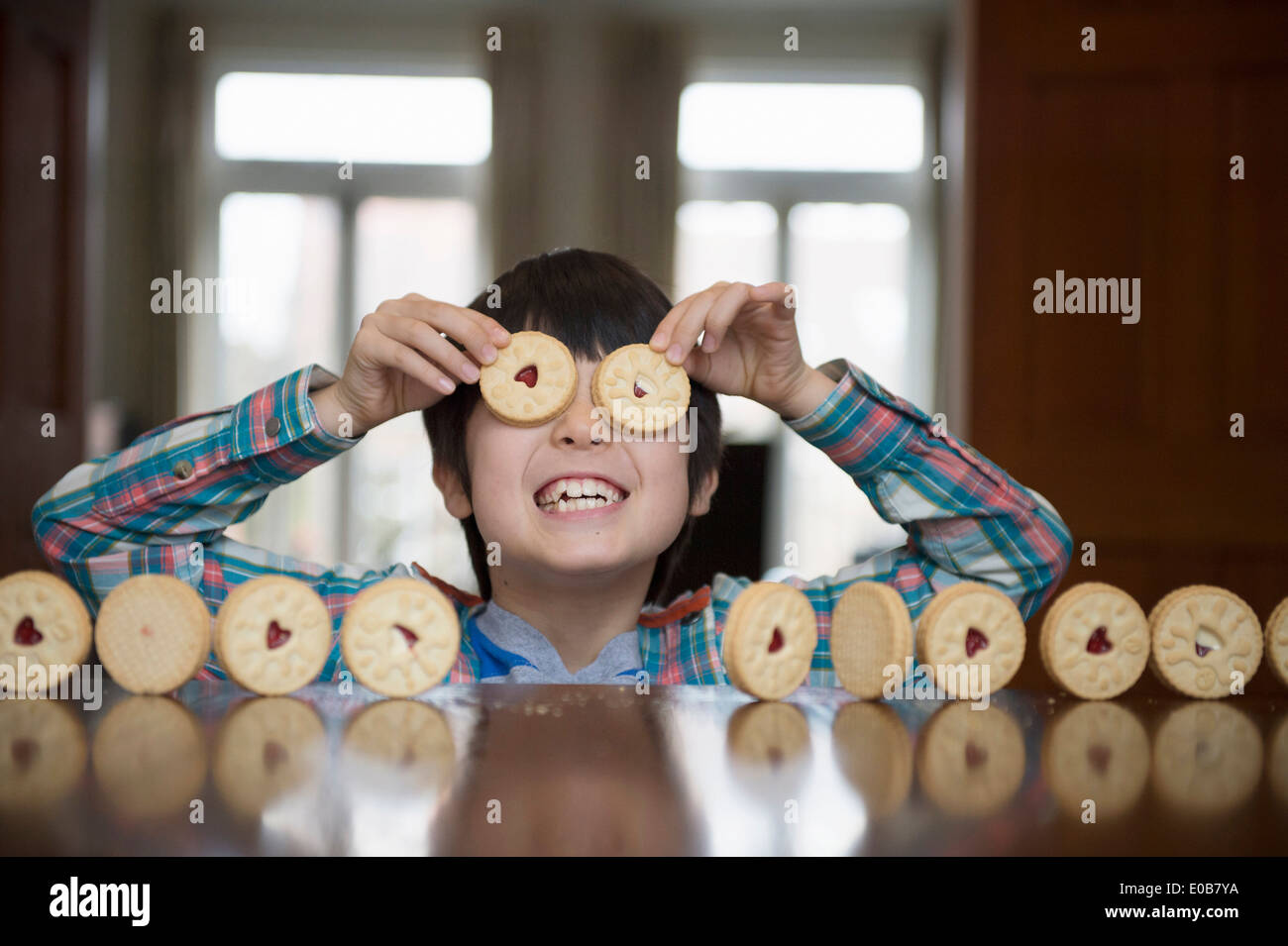 Boy playing with biscuits Stock Photo - Alamy