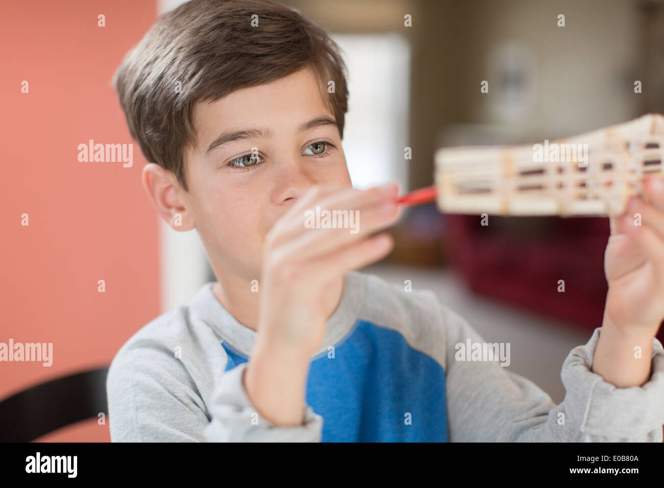 Boy holding up handmade model Stock Photo - Alamy