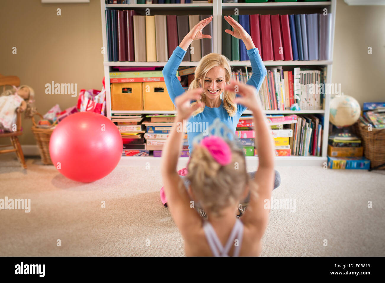 Mother and young daughter practicing ballet in sitting room Stock Photo ...