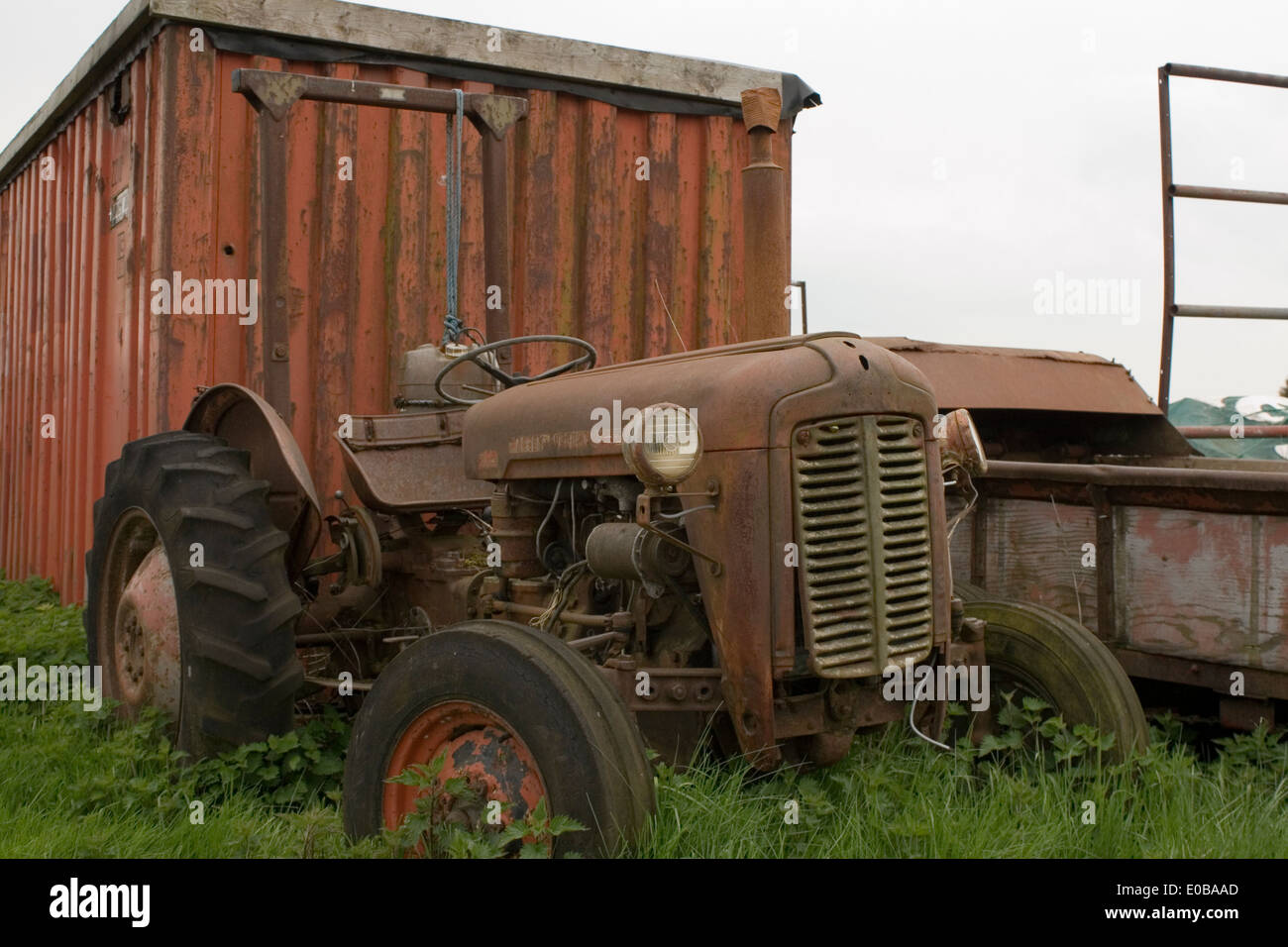 old rusting tractor left in the undergrowth Stock Photo - Alamy