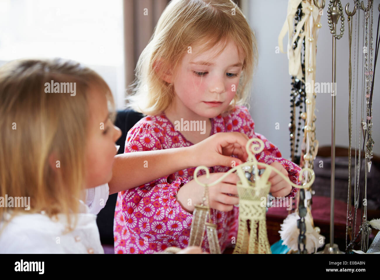 Two Girls Playing With Jewelry And Make Up Stock Photo - Alamy