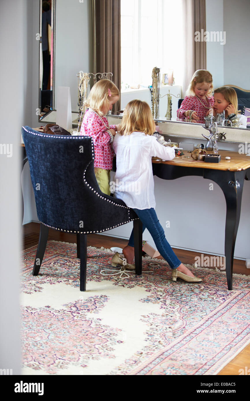 Two Girls Playing With Jewelry And Make Up Stock Photo - Alamy