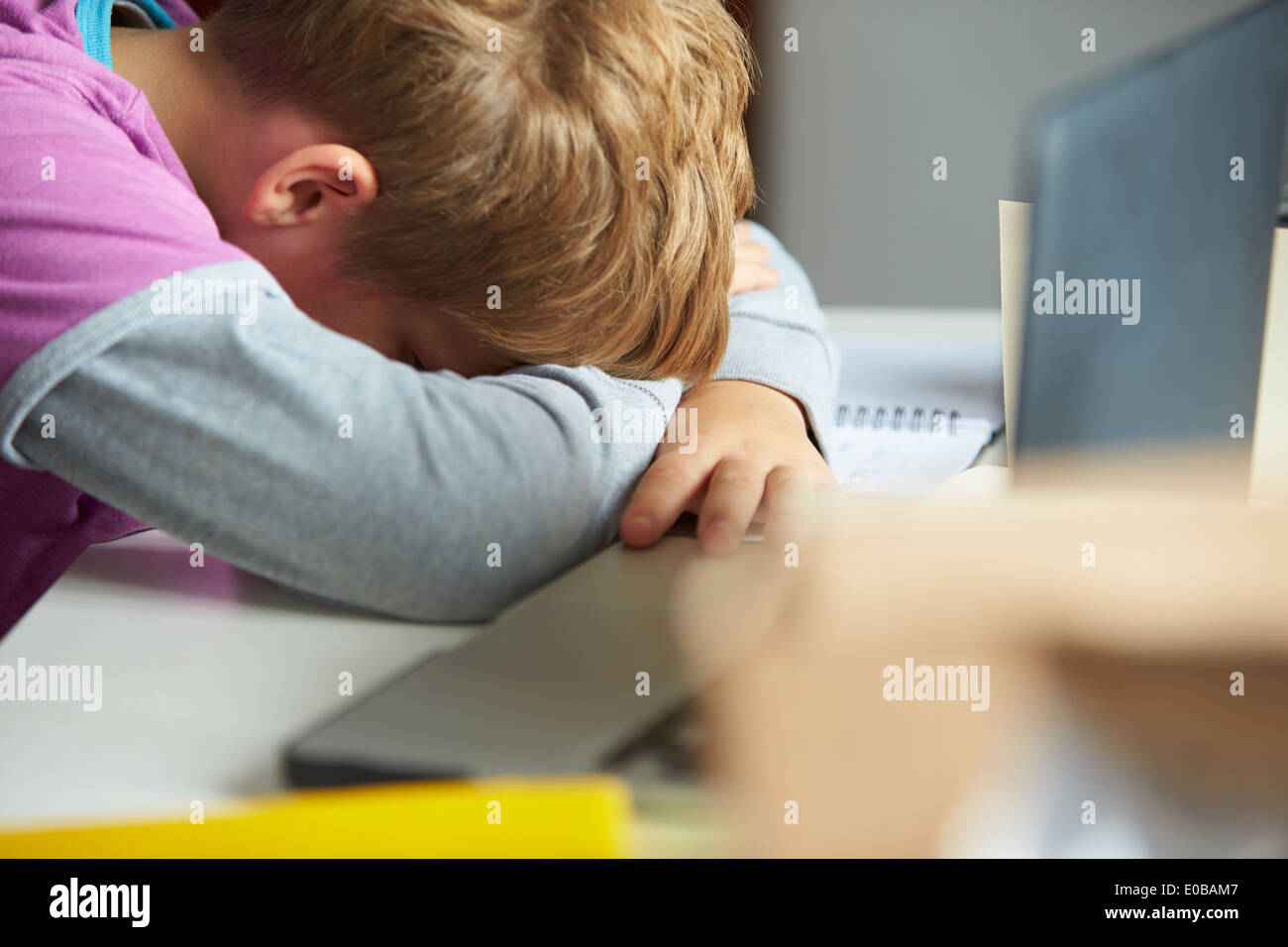 Tired Boy Studying In Bedroom Stock Photo - Alamy