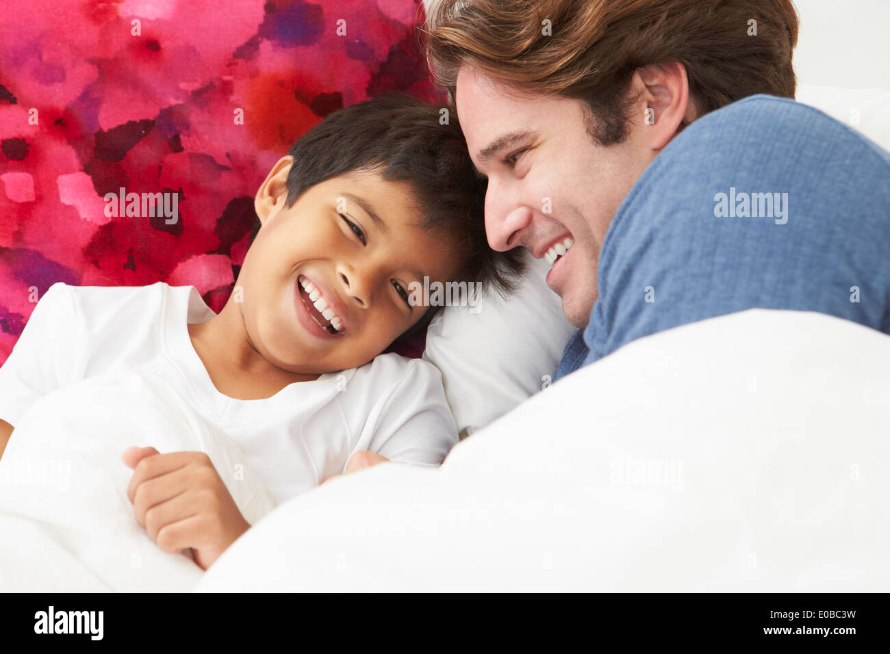 Father And Son Lying In Bed Together Stock Photo - Alamy