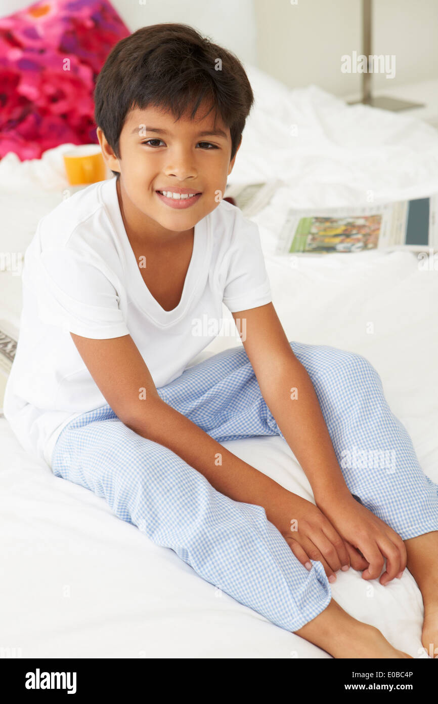 Boy Lying On Bed In Pajamas Together Stock Photo - Alamy