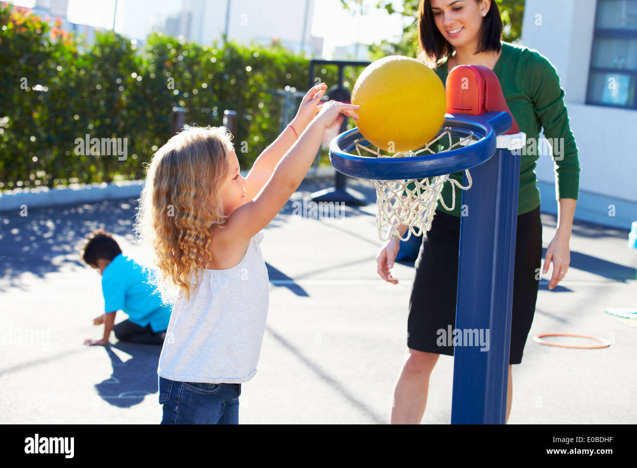 Teacher Supervising Breaktime At Elementary School Stock Photo - Alamy
