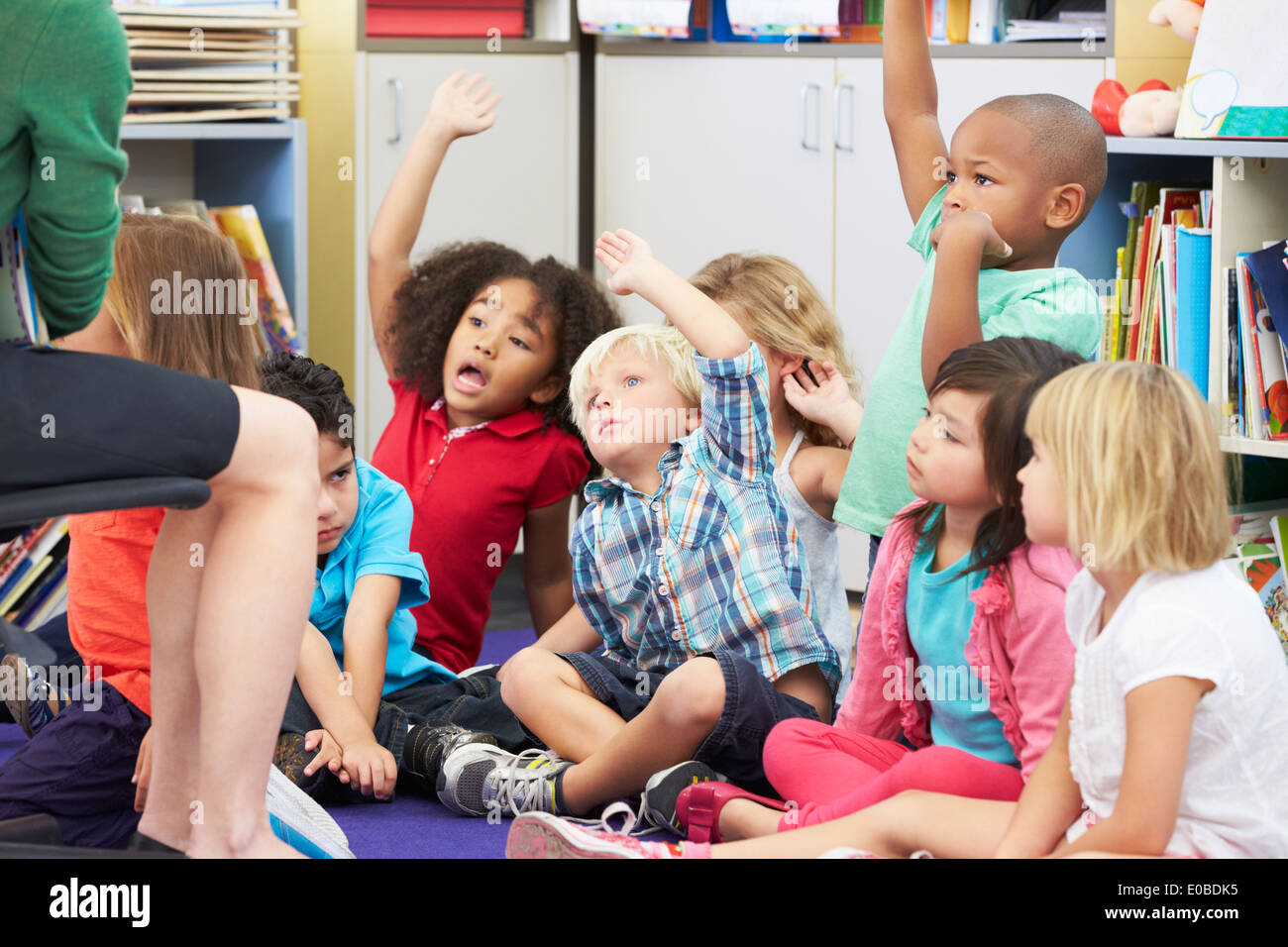 Group of Elementary Pupils In Classroom Answering Question Stock Photo ...