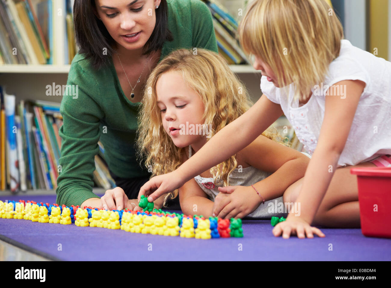Elementary Pupils Counting With Teacher In Classroom Stock Photo - Alamy