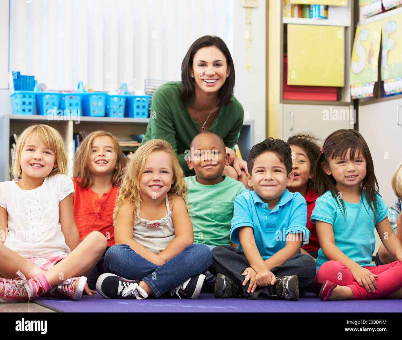 Group of Elementary Pupils In Classroom With Teacher Stock Photo - Alamy