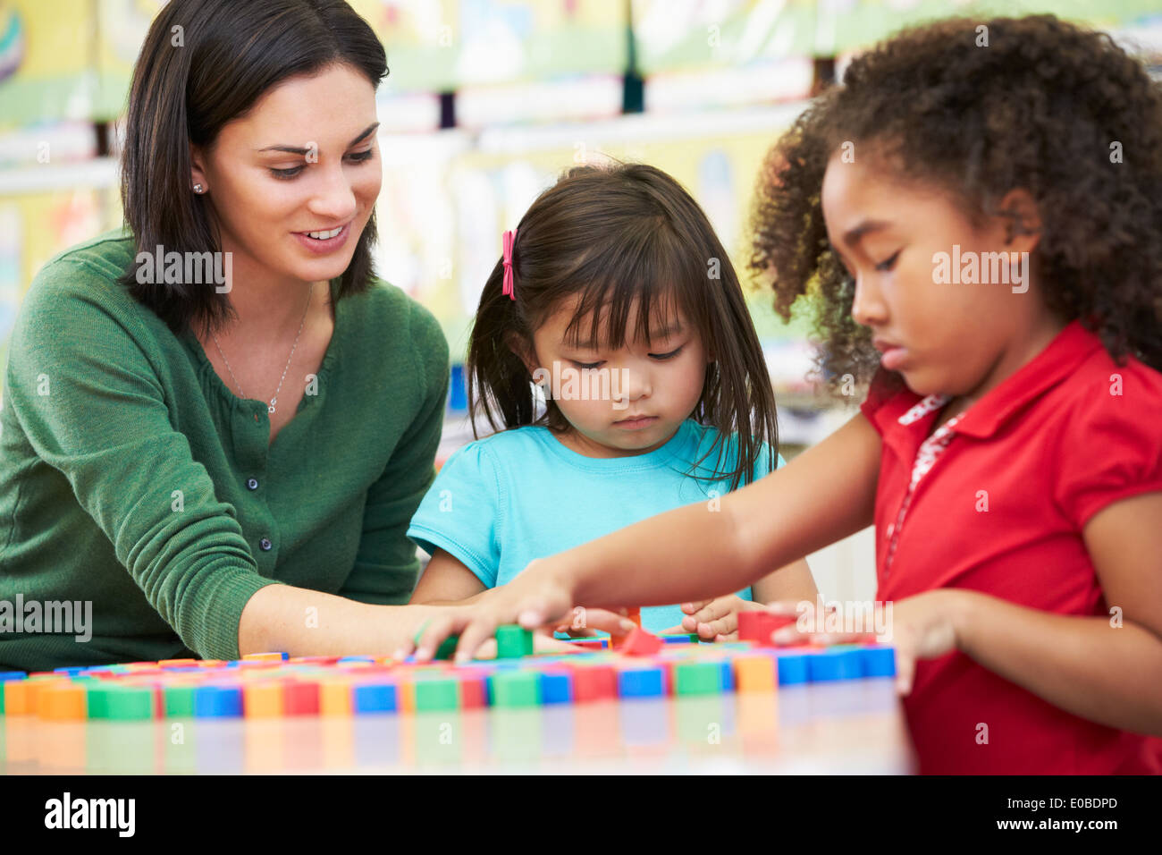 Elementary Pupils Counting With Teacher In Classroom Stock Photo - Alamy