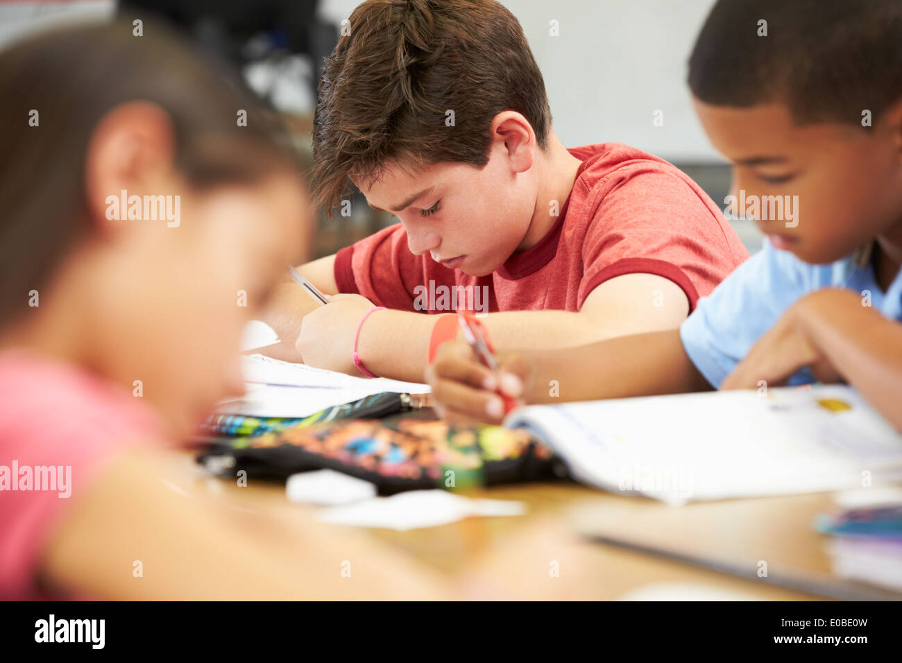 Pupils Studying At Desks In Classroom Stock Photo - Alamy