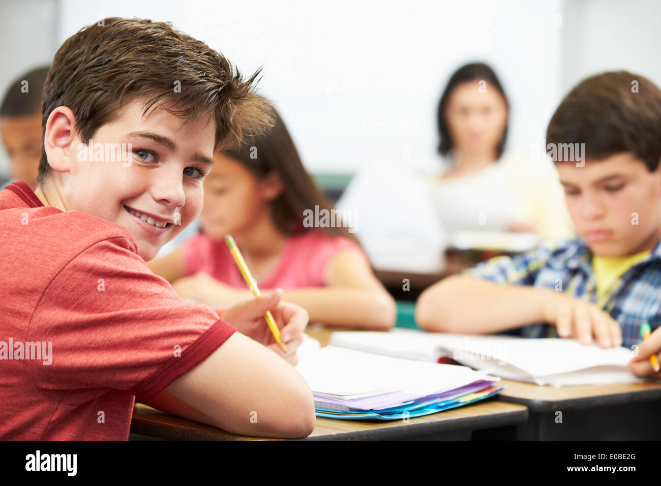 Pupils Studying At Desks In Classroom Stock Photo - Alamy