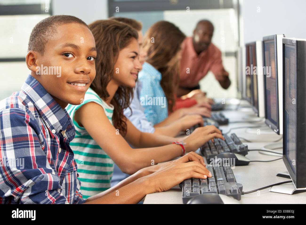 Group Of Students Working At Computers In Classroom Stock Photo - Alamy