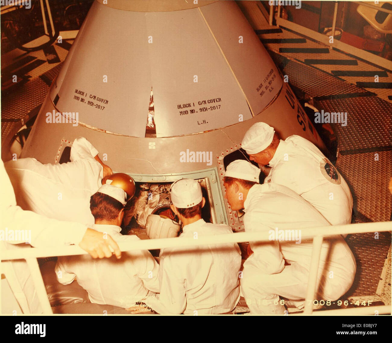 This photo captures an astronaut transferring into the Apollo capsule ...