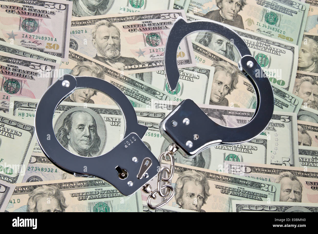 A lot of dollar of bank notes with handcuffs. Criminal activity and ...