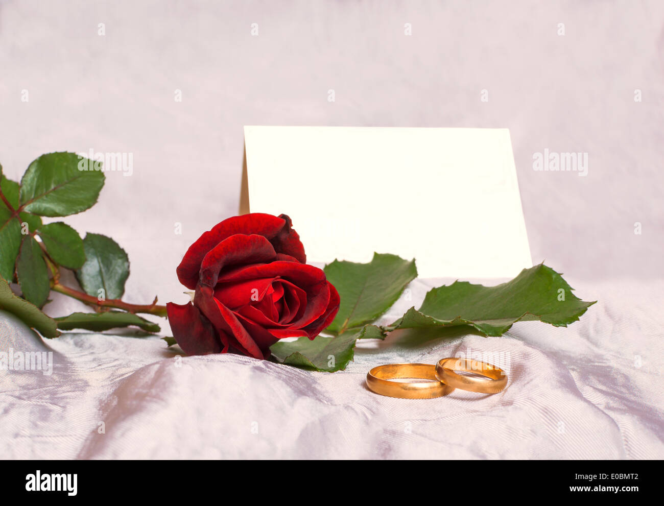 Beautiful red rose and wedding ring with card Stock Photo - Alamy