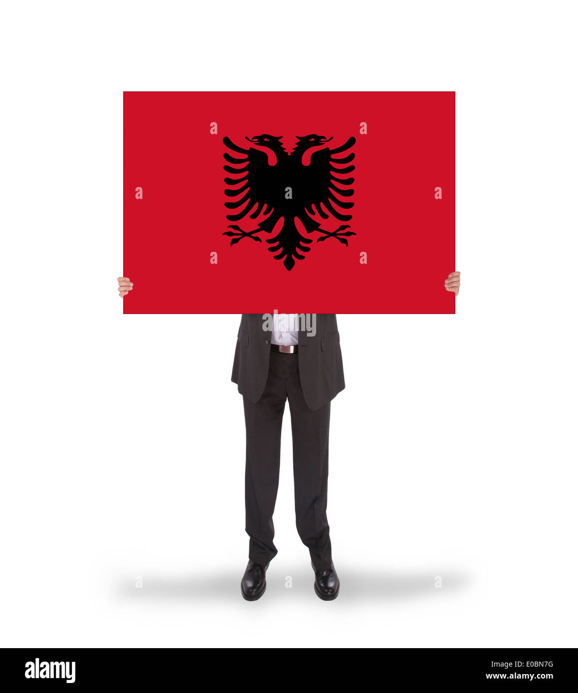 Businessman holding a big card flag of Albania isolated on white Stock ...
