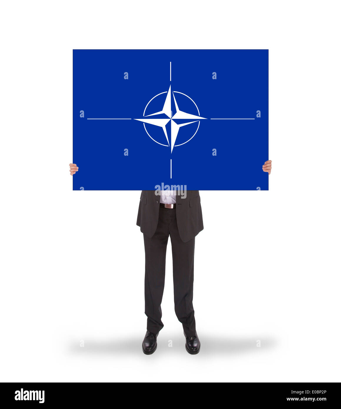 Businessman holding a big card NATO symbol isolated on white Stock ...