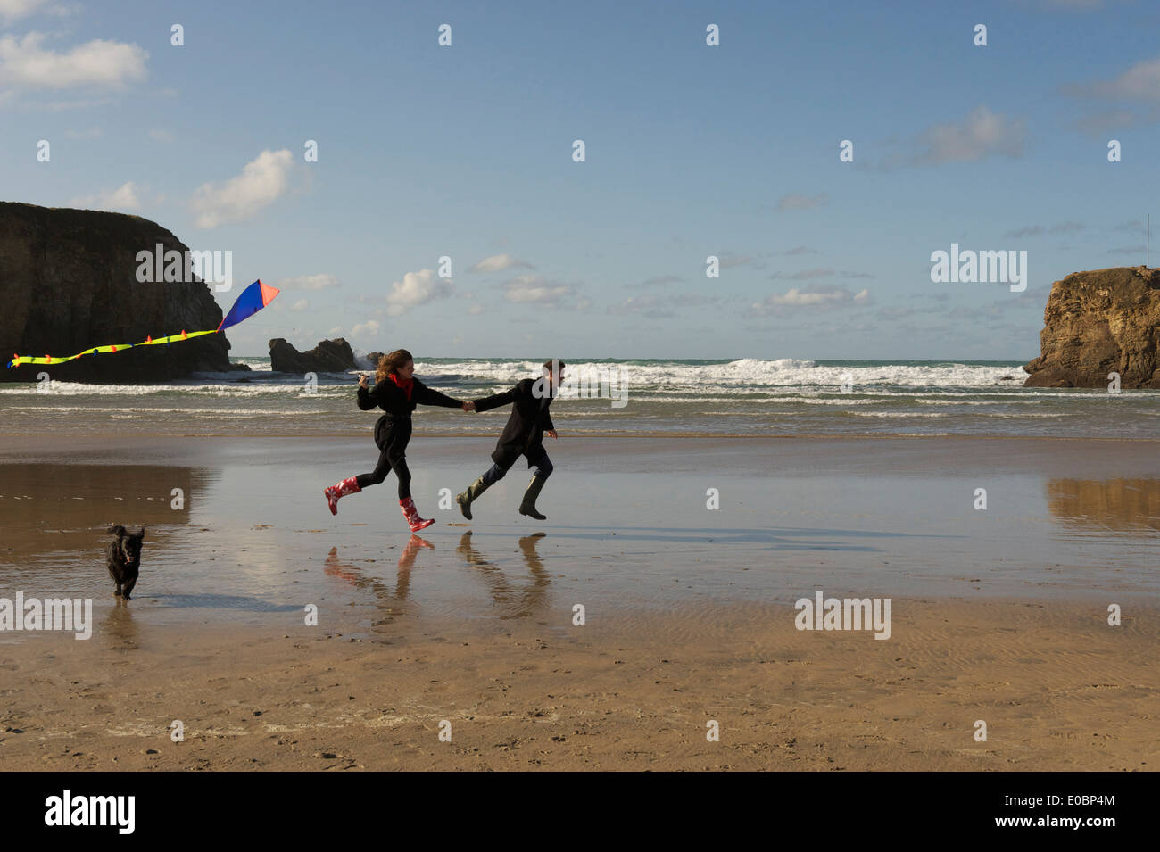 Young Romantic Couple flying their kite on a Beautiful Cornish Beach ...