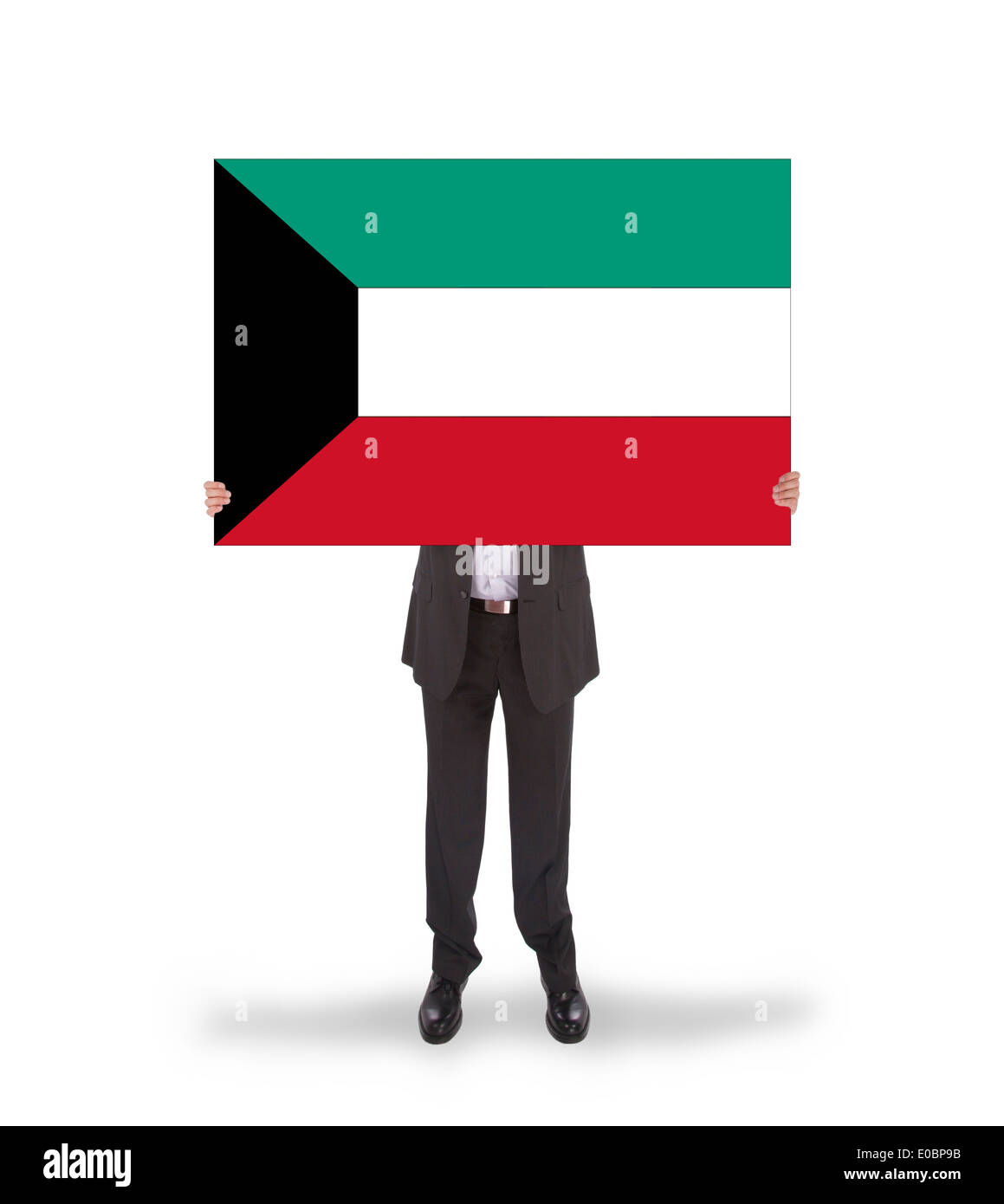 Businessman holding a big card flag of Kuwait isolated on white Stock ...