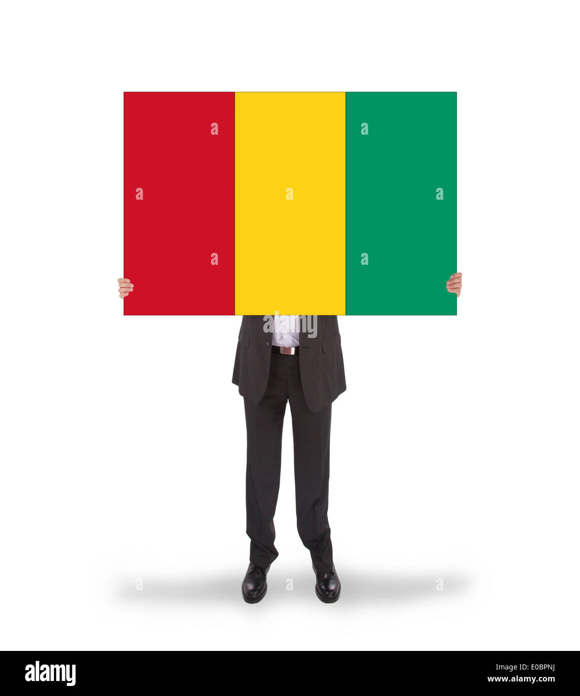 Businessman holding a big card flag of Guinea isolated on white Stock ...