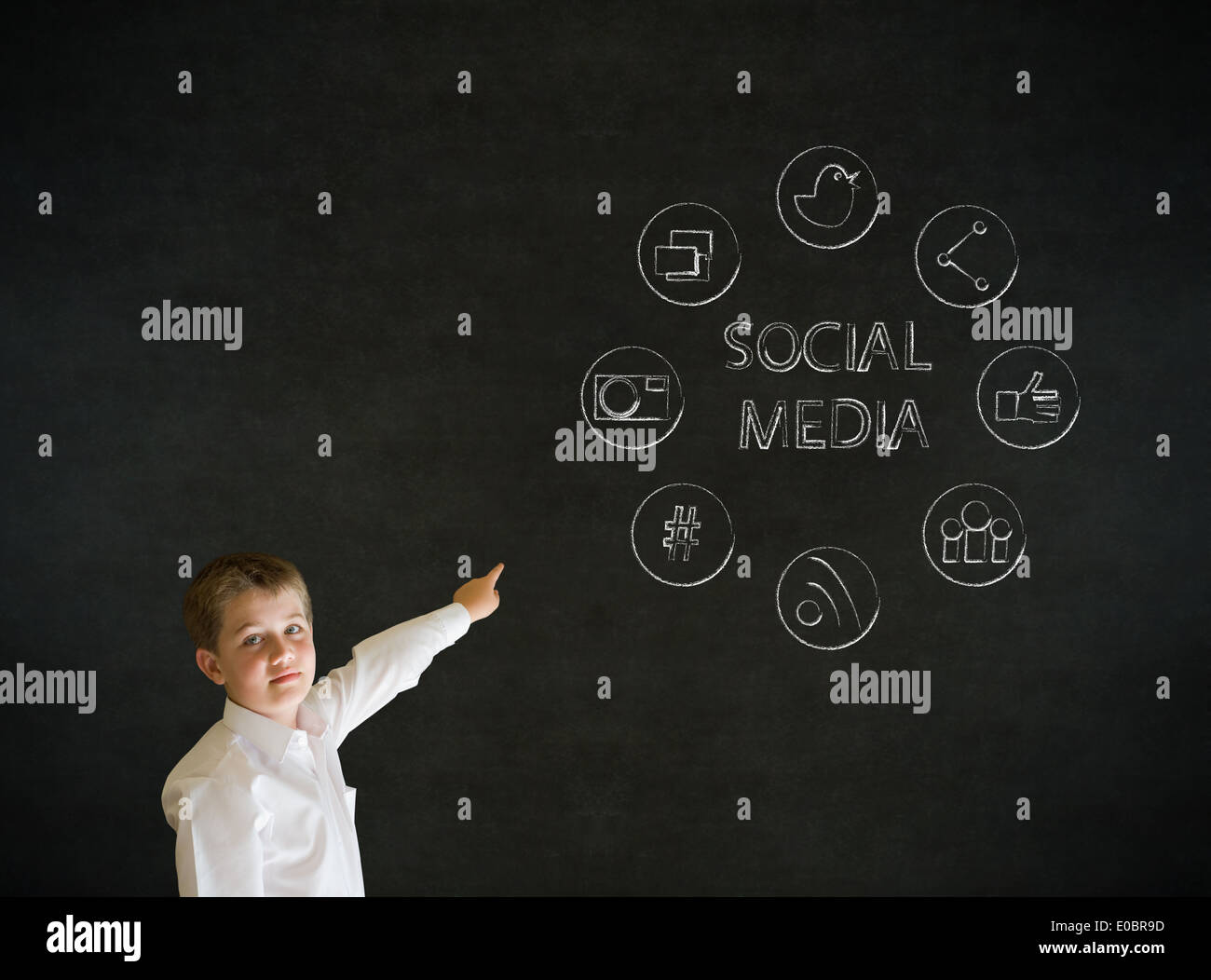Pointing boy dressed up as business man with social media icons on ...