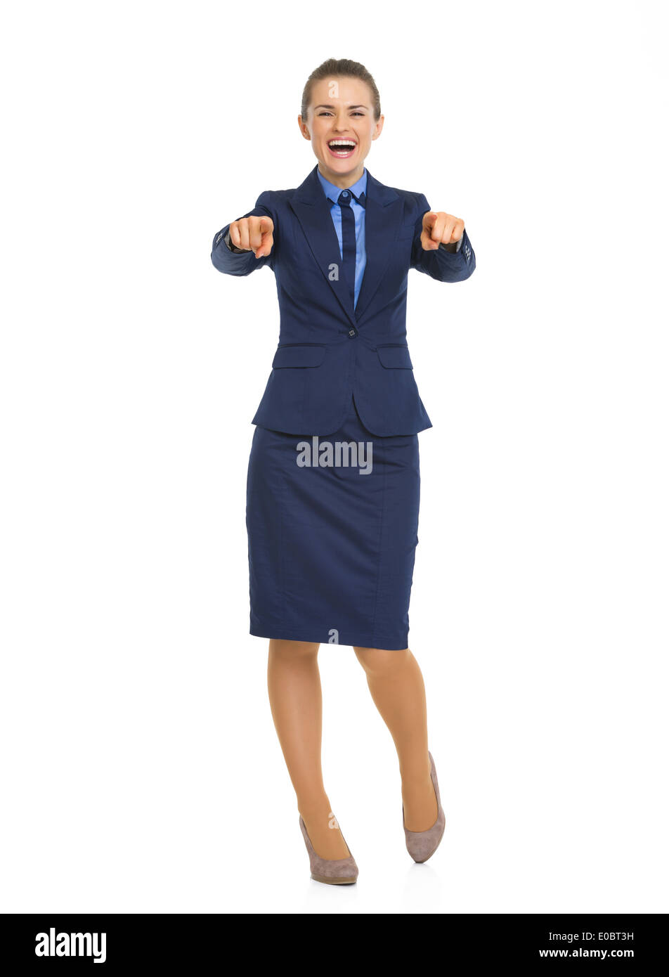 Full length portrait of smiling business woman pointing in camera Stock ...