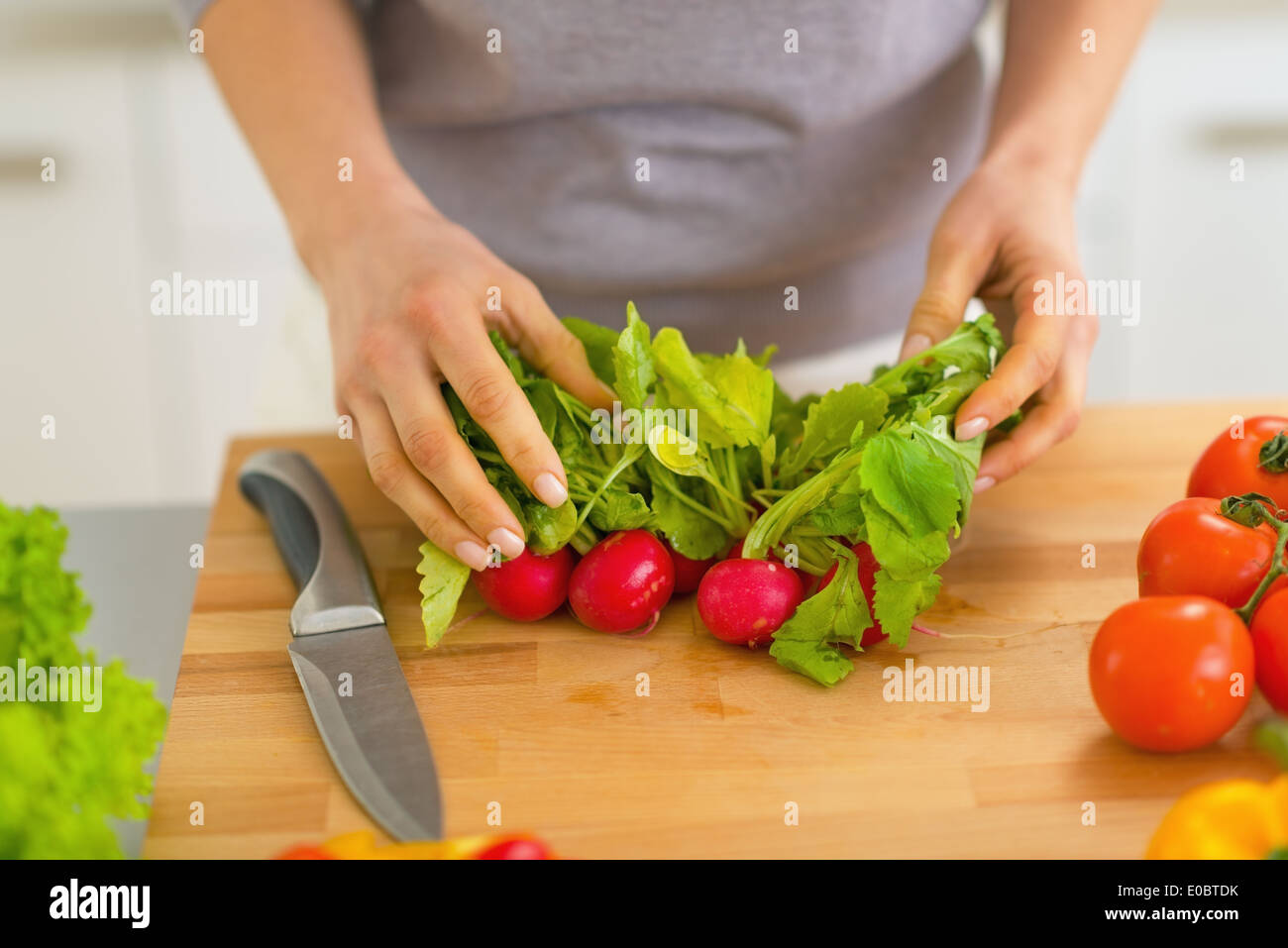 Closeup on young woman cutting radishes Stock Photo - Alamy