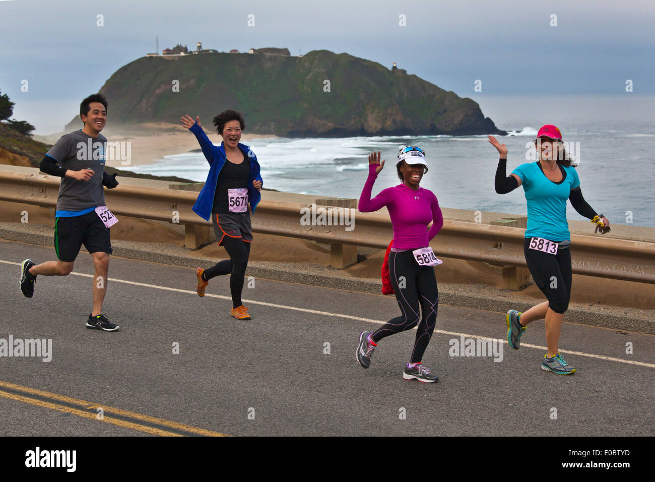 Runners pass the Point Sur lighthouse during the 2014 Big Sur Marathon ...