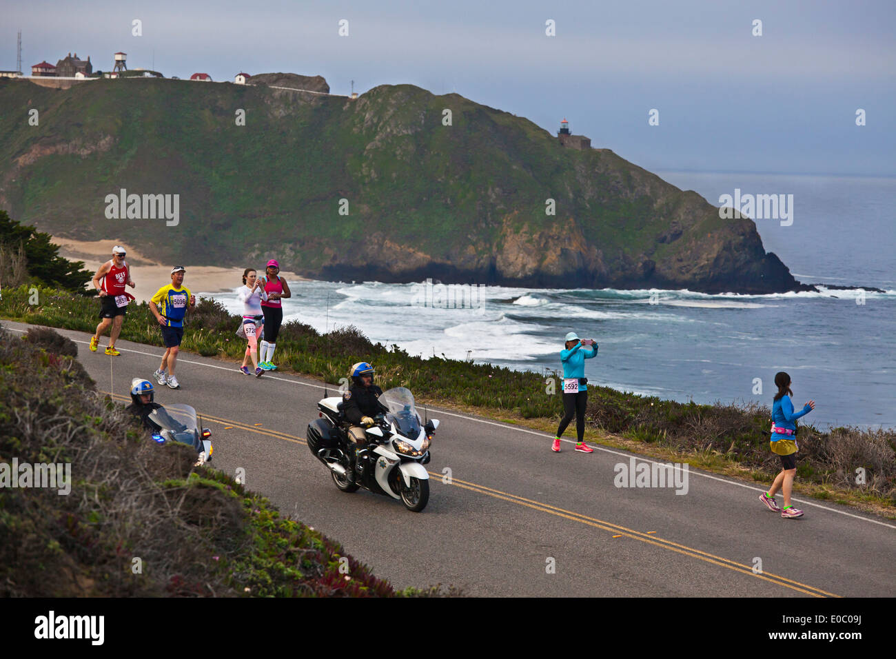 Runners pass the Point Sur lighthouse during the 2014 Big Sur Marathon ...