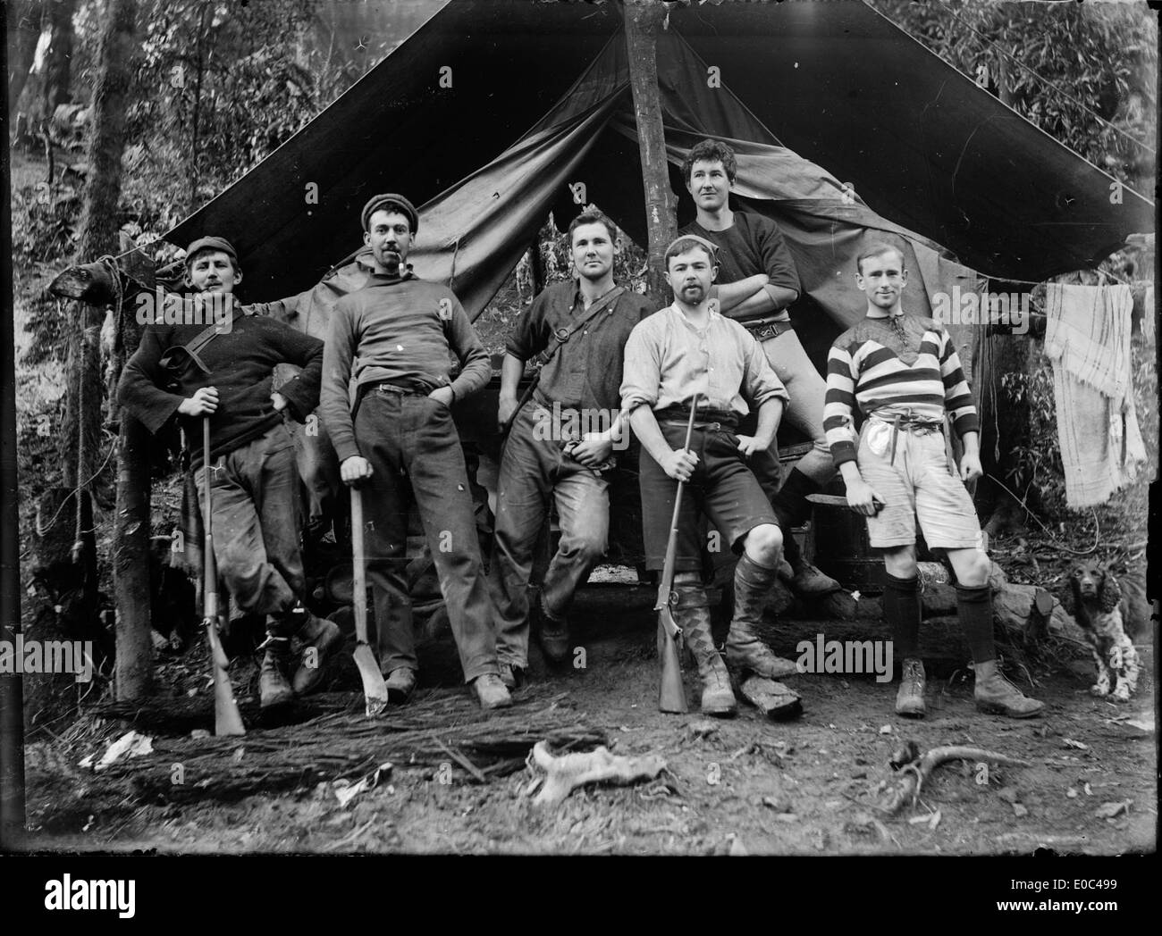 A photograph from the early 1900s depicting a group of hunters outside ...