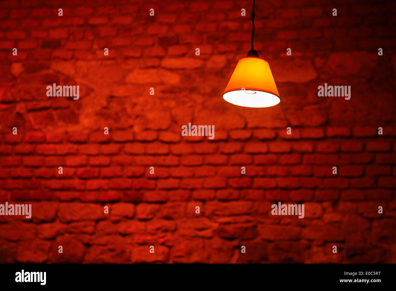 lighting lamp with red brick wall background Stock Photo - Alamy