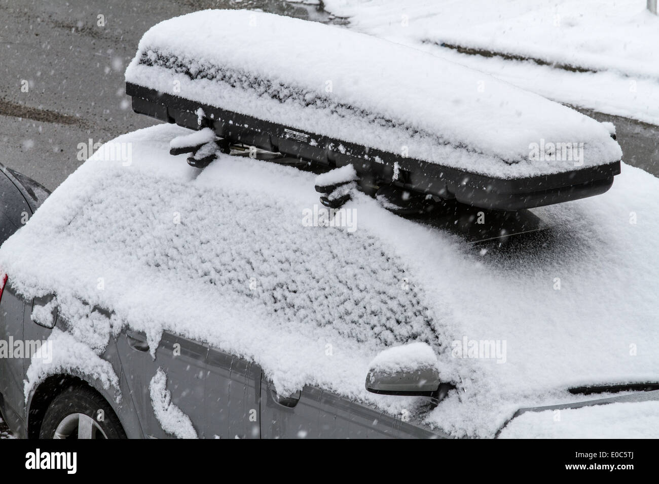 Winter scene, car covered with light dusting of snow, needing to be ...