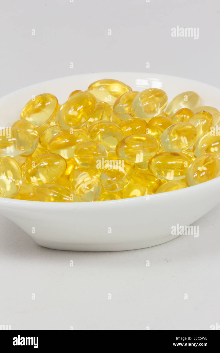 Cod liver oil capsules isolated on white background Stock Photo - Alamy